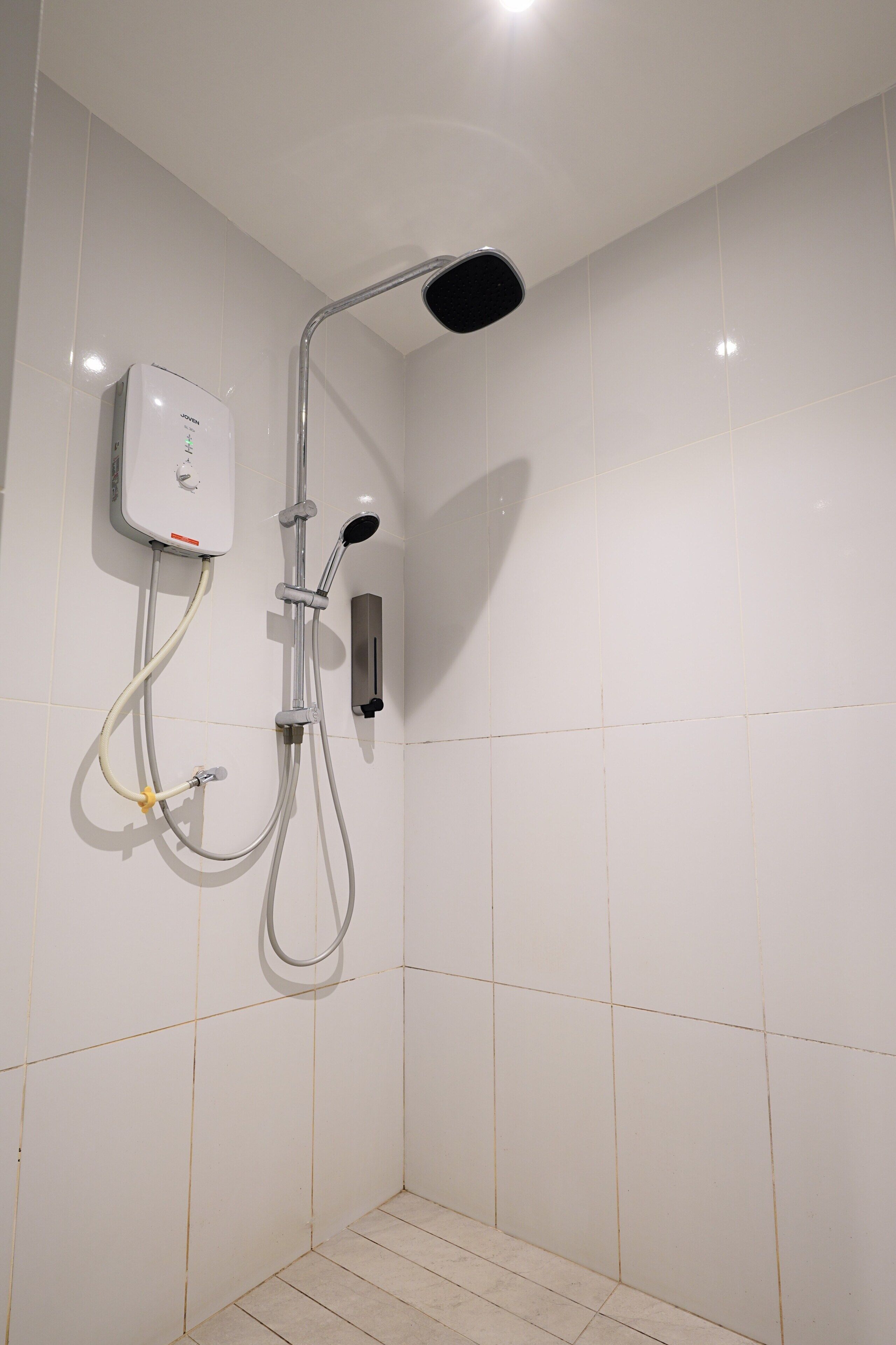 Um chuveiro moderno com um chuveiro manual e um painel de controle fixado na parede.