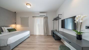 Suite-Estúdio Deluxe | Cofre no quarto, secretária