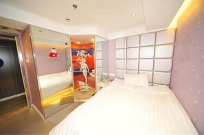 Quarto de hotel moderno com uma cama grande, divisória de vidro e banheiro visível através dela.
