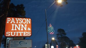 Placa do Payson Inn & Suites com decoração de árvore de Natal.