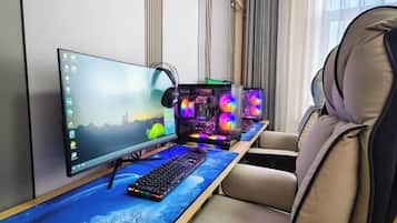 Configuração de jogos com monitor, teclado e iluminação RGB.