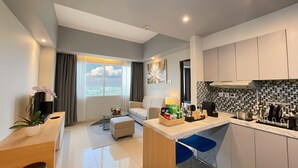 Um apartamento moderno com cozinha, sala de estar e varanda com vista para a cidade.