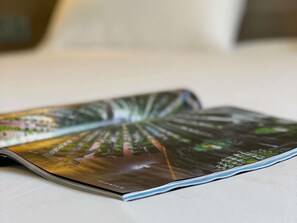 Revista ou folheto com encadernação em espiral sobre uma superfície branca.