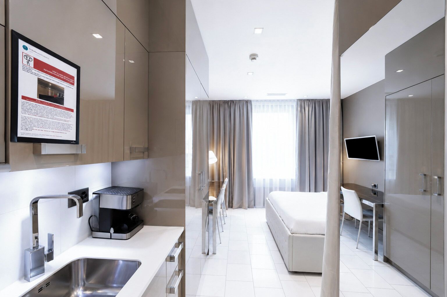 Quarto de hotel moderno com cozinha compacta, uma cama, uma escrivaninha e uma televisão.