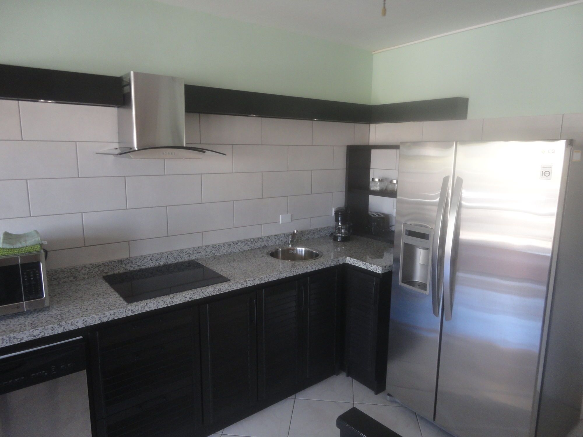 Um frigorífico/congelador grande, um micro-ondas, uma placa de cozinha 