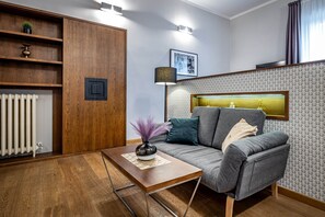 Suíte estúdio luxo, 1 cama King | Área de estar | TV de tela plana 55 polegadas com canais via satélite, TV