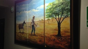 Pintura de um homem com uma mula e uma árvore.