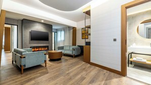 Uma sala de estar moderna com lareira, sofás e televisão.