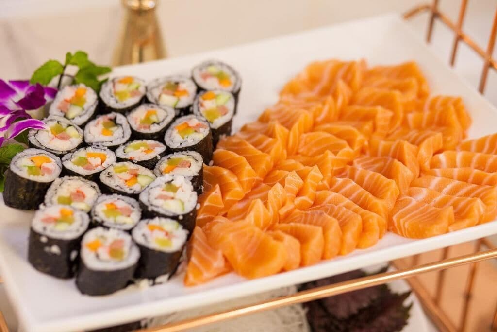 Uma travessa de sushi e fatias de salmão.