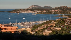 Uma vila costeira com um porto, barcos e edifícios.