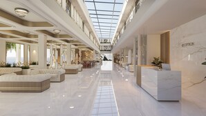 Um hall amplo com teto alto, luminárias modernas, assentos confortáveis e uma mesa de recepção.