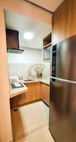 Apartamento de Luxo | Cozinha privada | Um micro-ondas, utensílios de cozinha, mesas de jantar 