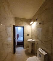 Quarto Duplo Deluxe | Casa de banho | Um polibã, artigos de higiene pessoal grátis, toalhas fornecidas, sabão 