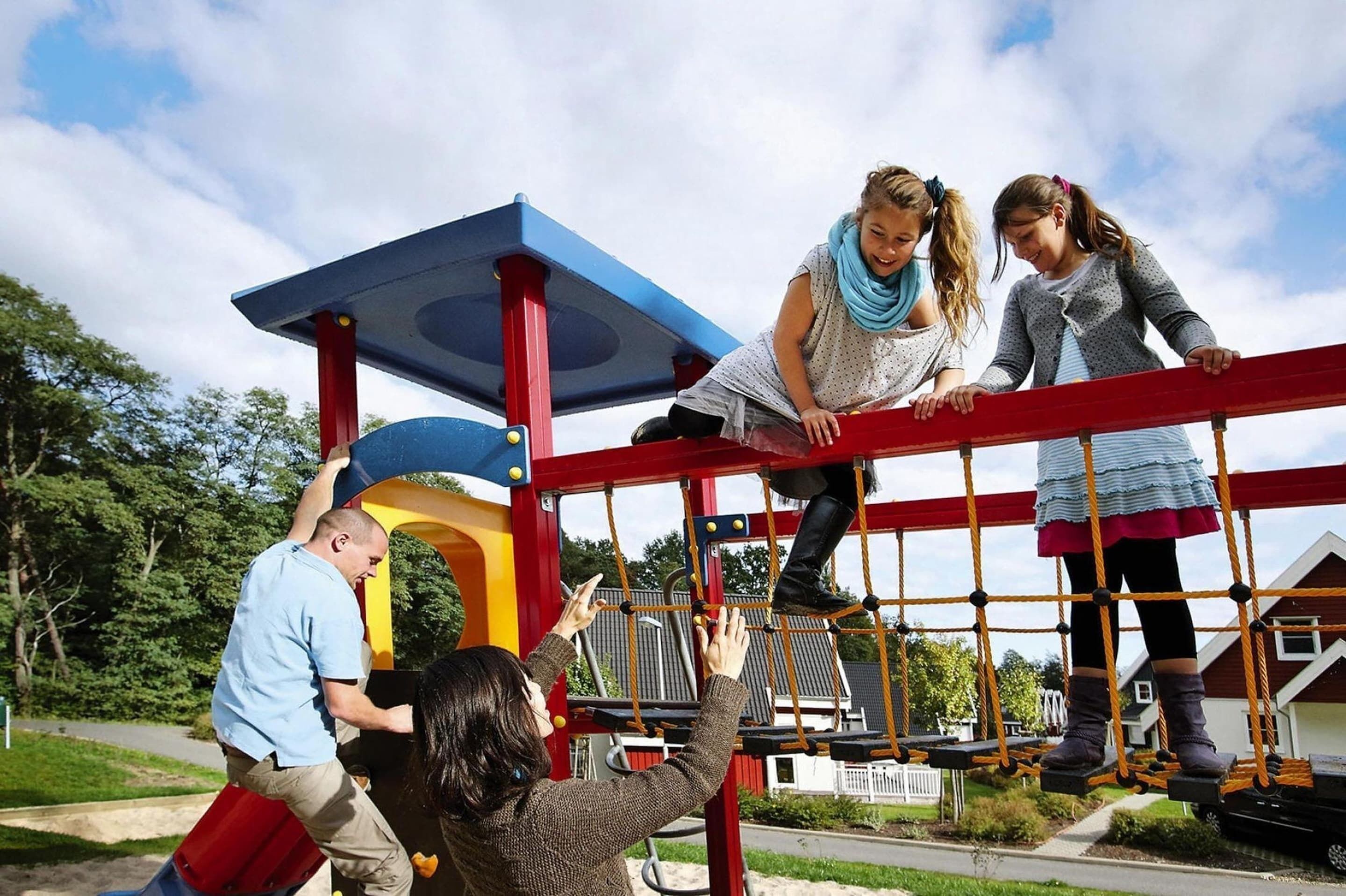 Uma área de lazer infantil com estrutura de escalada e escorrega.