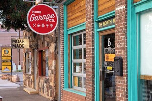 A building with a sign for Moab Garage Co. and a sign for Moab Made.