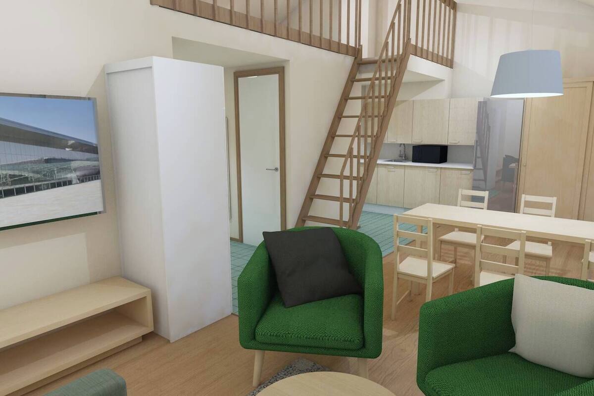 Um apartamento moderno com cozinha, área de jantar e escada para um andar superior.
