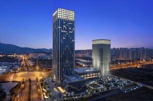 Um edifício moderno e imponente com fachada de vidro e entrada destacada.