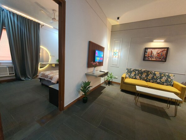 Suíte estúdio superluxo, vista para a cidade | Área de estar | TV, impressoras