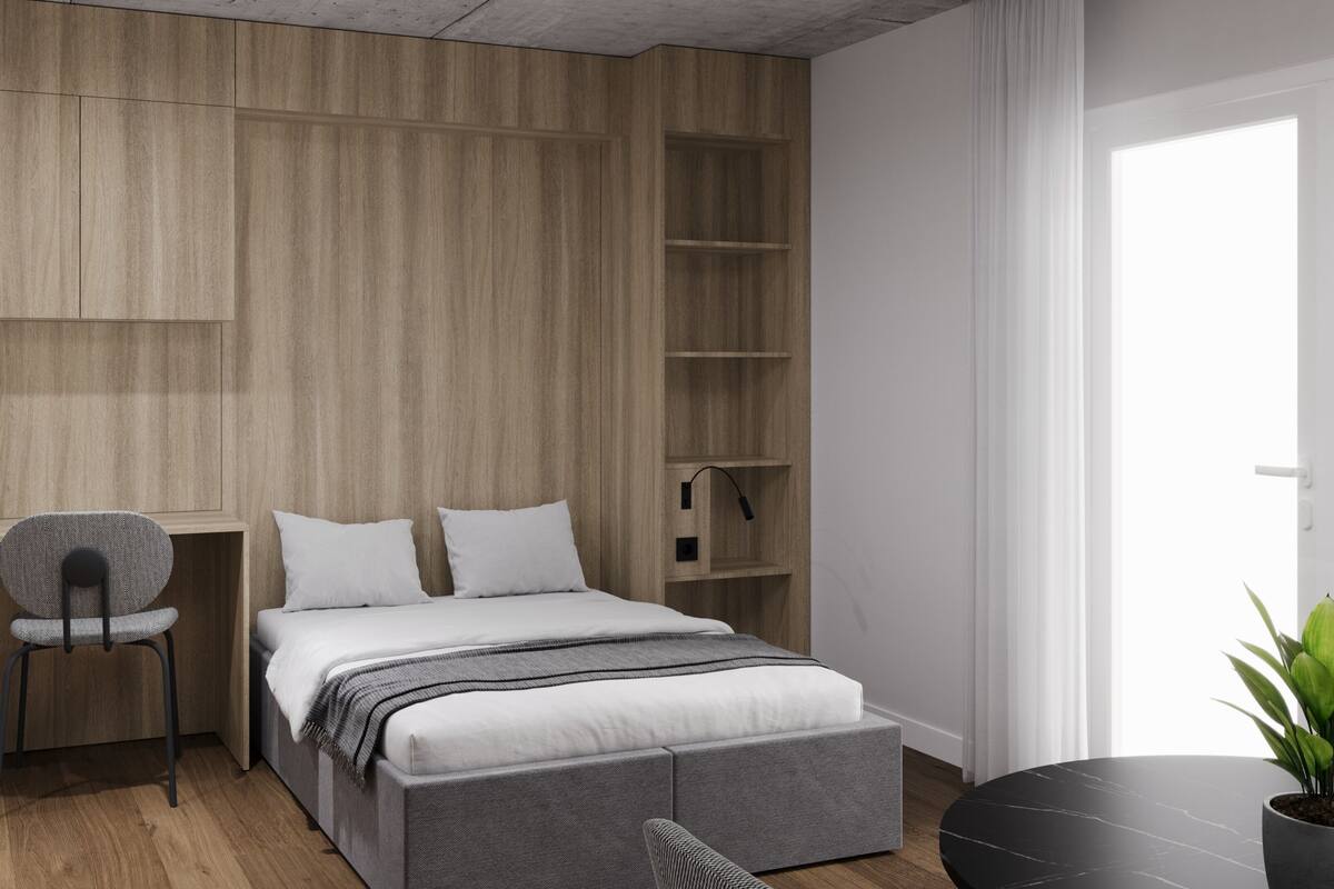 Quarto moderno com uma cama, uma escrivaninha e uma cadeira.