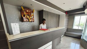 Uma receção com design moderno, zona de estar e parede decorativa.