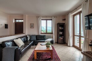 Villa, vista para o lago | Sala de estar | Televisor de 30 polegadas com canais digitais 