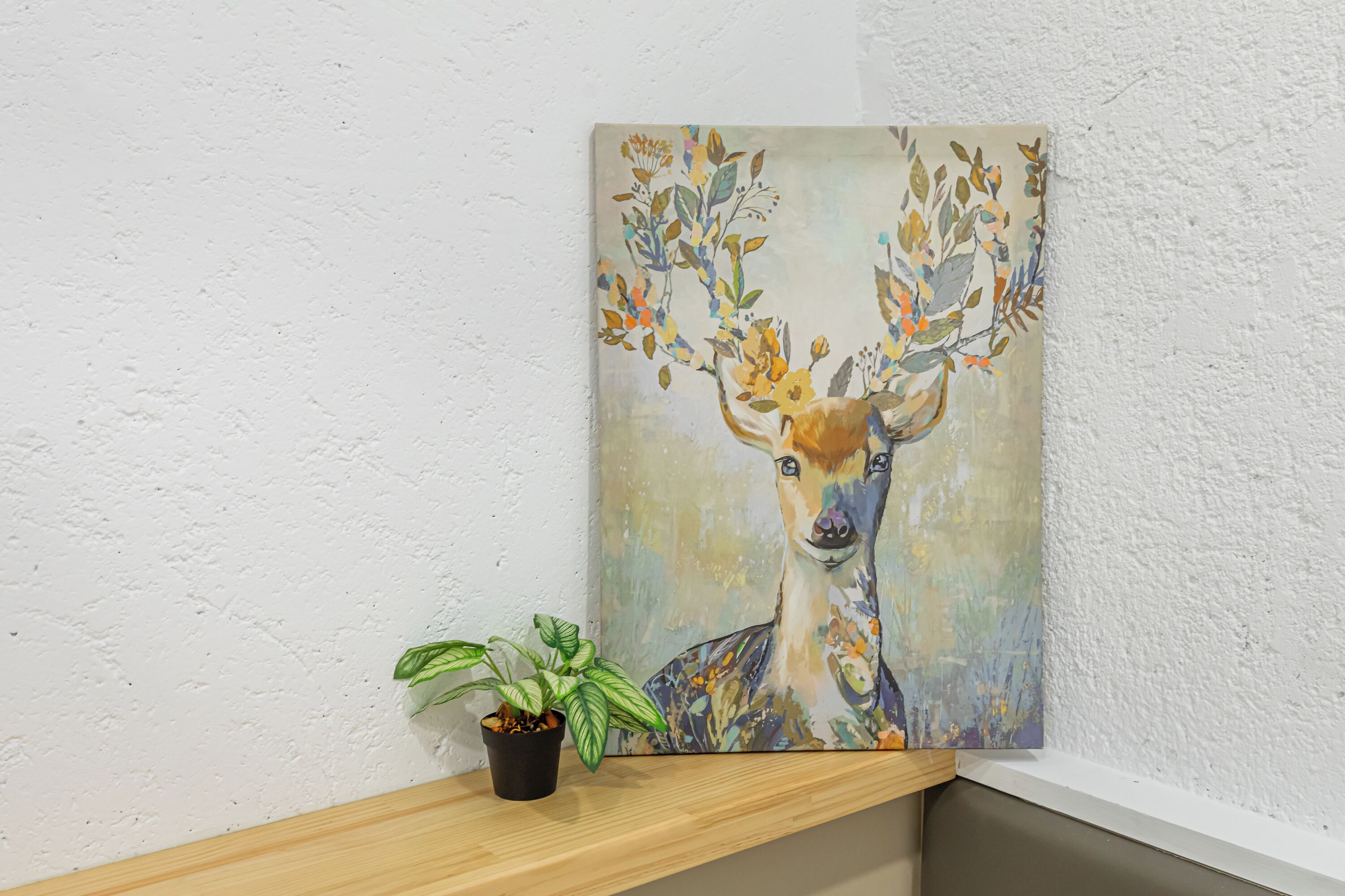 Pintura de um veado com chifres na parede.