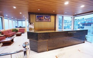 Uma área de recepção com balcão, sofá e mesa de centro.