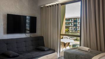 Apartamento Comfort | Sala de estar | Televisor