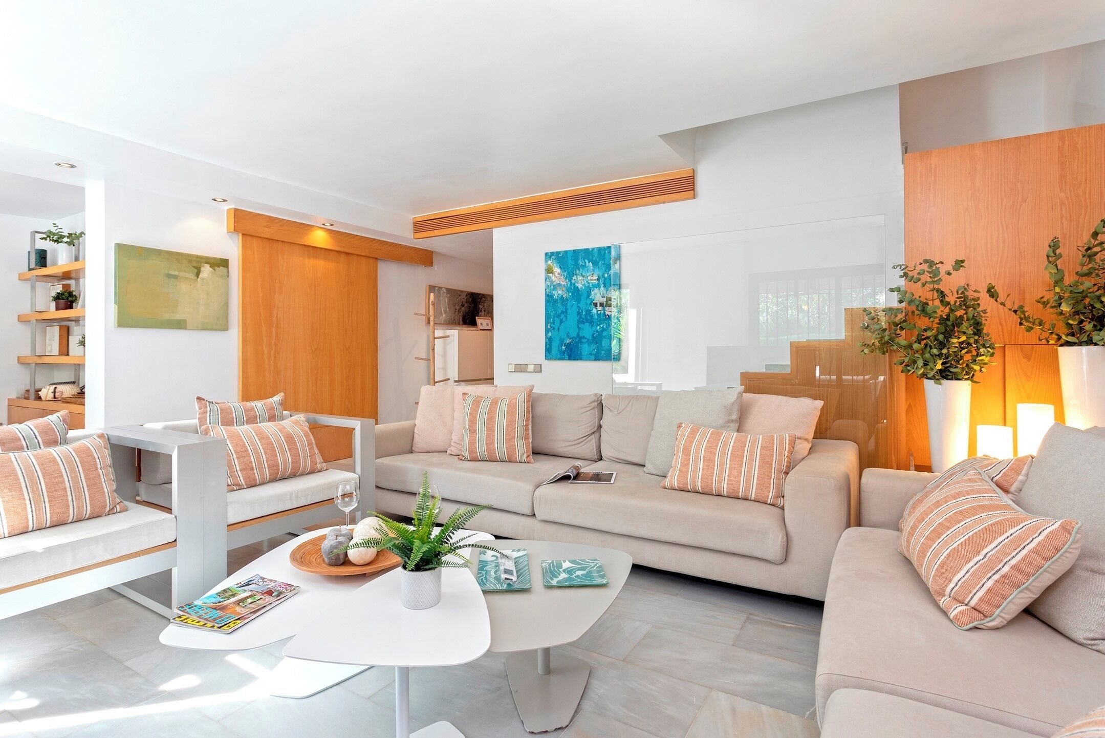 Uma sala de estar moderna com um conjunto de sofá, uma mesa de centro e uma estante.