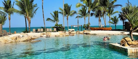 Na praia, praia de areia branca, espreguiçadeiras, guarda-sóis de praia