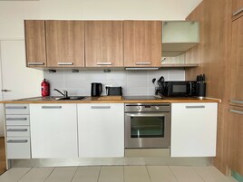 Apartamento superluxo, vista para a cidade | Cozinha privada | Geladeira, micro-ondas, fogão, cooktop