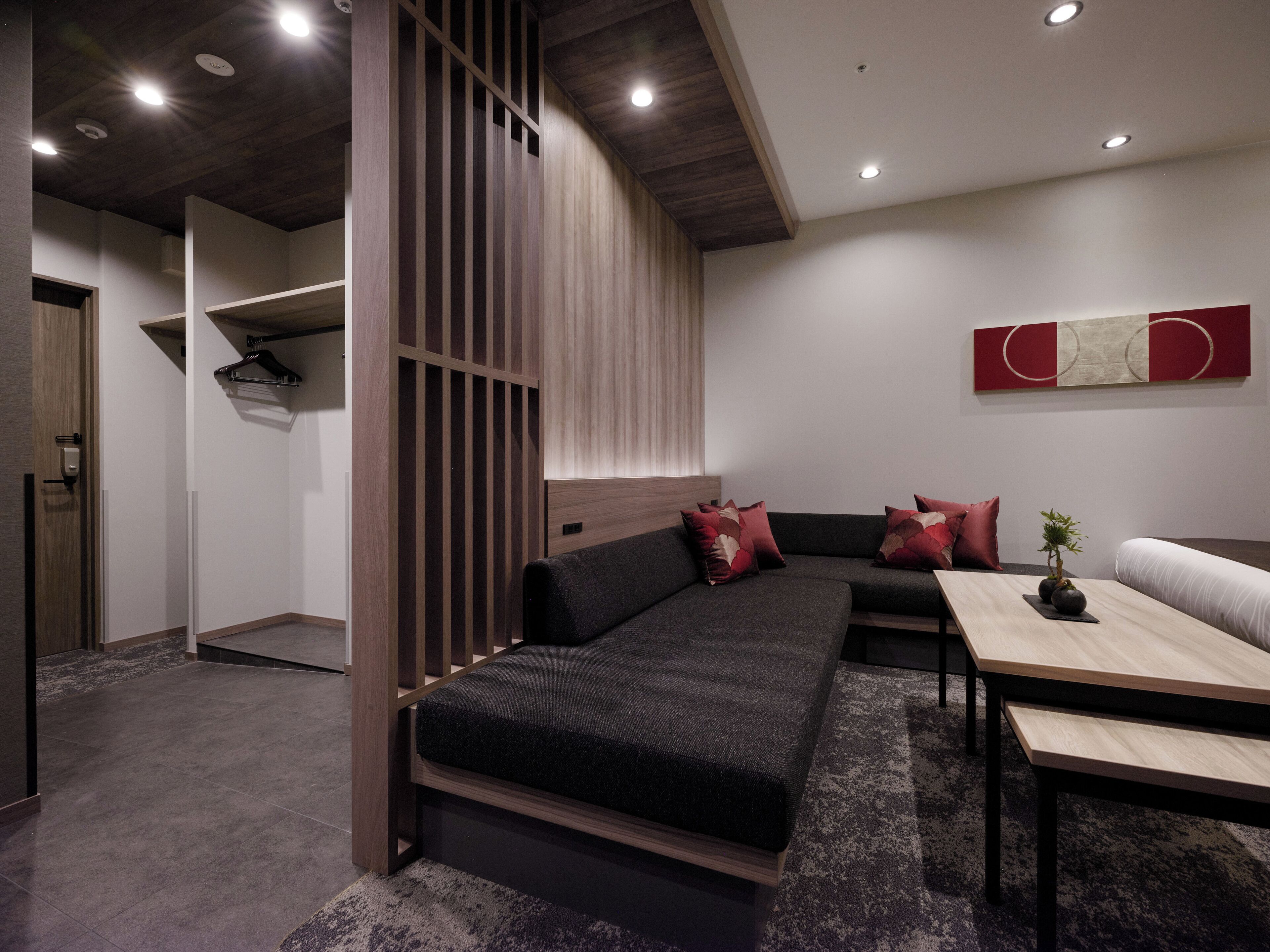 Um interior moderno com sofá em forma de L, uma parede de destaque em madeira e design minimalista.