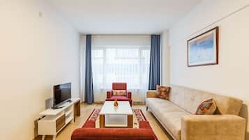 Apartamento, 2 quartos, varanda, vista para o jardim | Sala | Livros