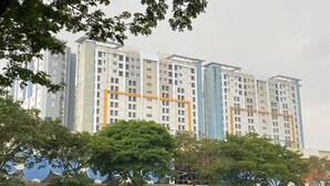 Um edifício residencial de vários andares com um design moderno, apresentando uma placa grande com a inscrição 