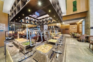 Uma área de buffet com vários pontos de alimentação e opções de assentos.