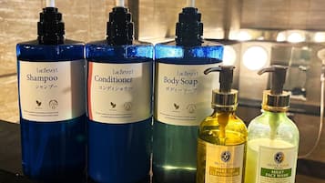 Quatro frascos de produtos de cuidados para a pele Lachevert e dois frascos de óleo de limpeza e sabonete facial da linha Olive Gold sobre um balcão.