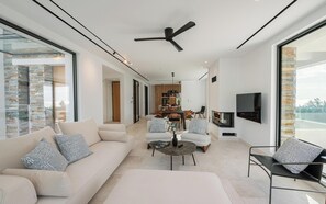 Villa Deluxe, vista para o mar | Sala | Smart TV de 55 de polegadas com canais via satélite, lareira, Netflix 