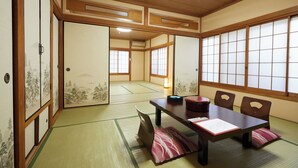 Um quarto japonês tradicional com tatames, painéis shoji e uma mesa de madeira baixa com almofadas.