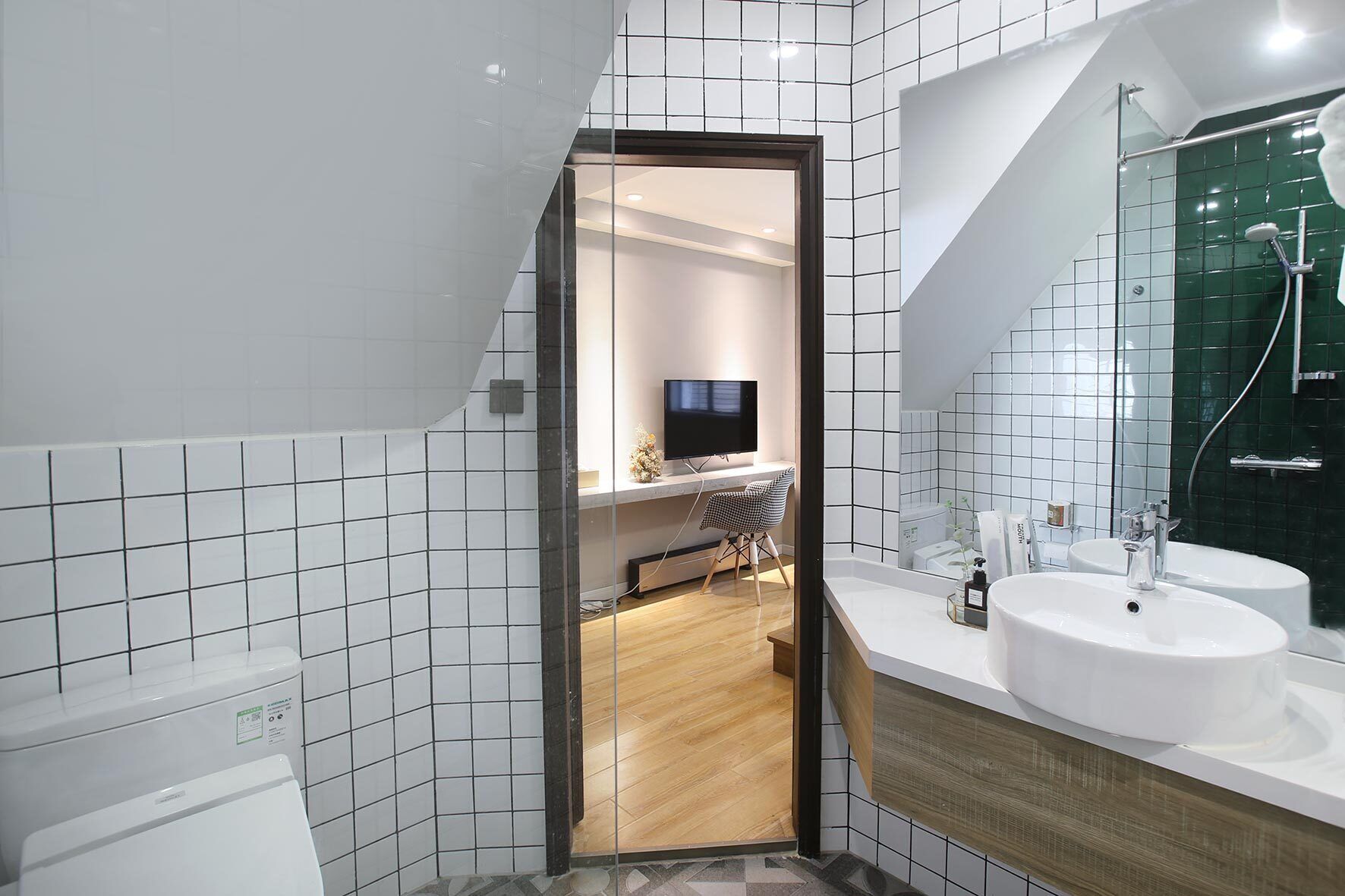 Um banheiro moderno com azulejos brancos e pretos, piso de madeira, um espelho grande e área de chuveiro.