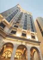 Exterior do Hotel Assaafa Golden, com suas janelas em arco características e sinalização iluminada.