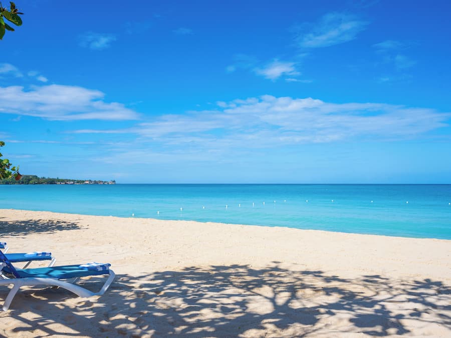 Na praia, praia de areia branca, espreguiçadeiras