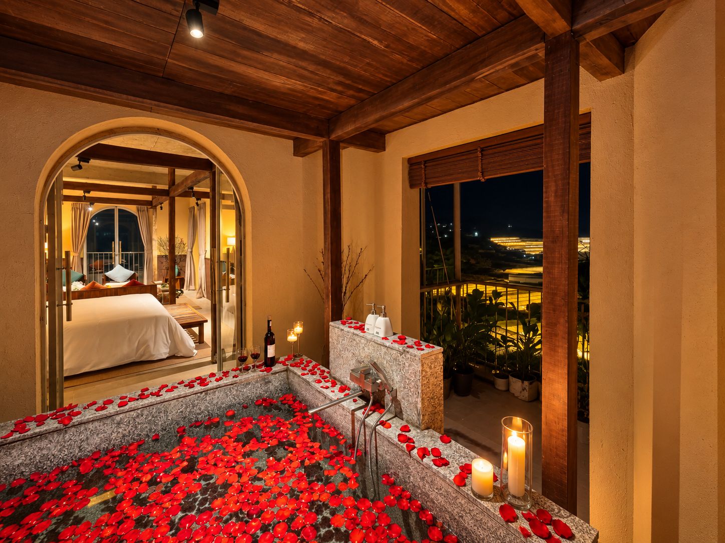 Quarto luxuoso com uma cama grande, varanda privativa e vista para a paisagem urbana à noite.