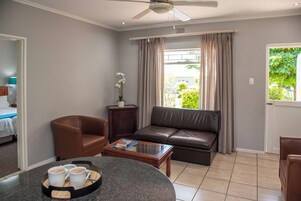 Chalé Comfort, vista para o jardim | Sala de estar | Televisor de 32 polegadas com canais via satélite 