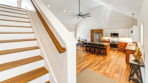 Uma cozinha moderna com piso de madeira, uma ilha central e um espaço para refeições.