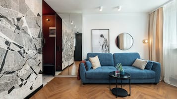 Apartamento conforto, vista para a cidade | Sala de estar | Smart TV 50 polegadas com canais a cabo, Netflix, serviços de streaming