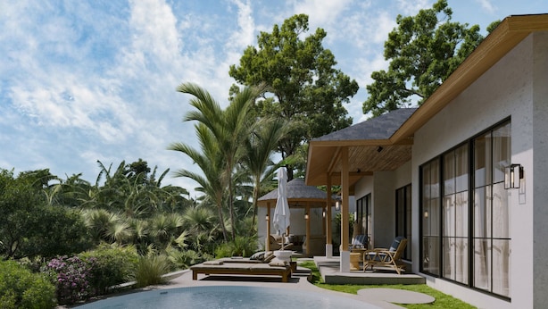 Uma casa moderna com piscina, móveis de exterior e vegetação exuberante.