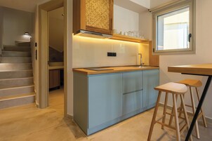 Minifrigorífico, uma placa de cozinha, utensílios de cozinha 