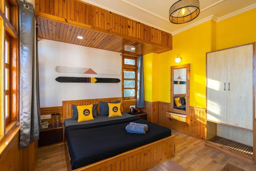 Quarto com painéis de madeira, uma cama, um guarda-roupa e uma janela.