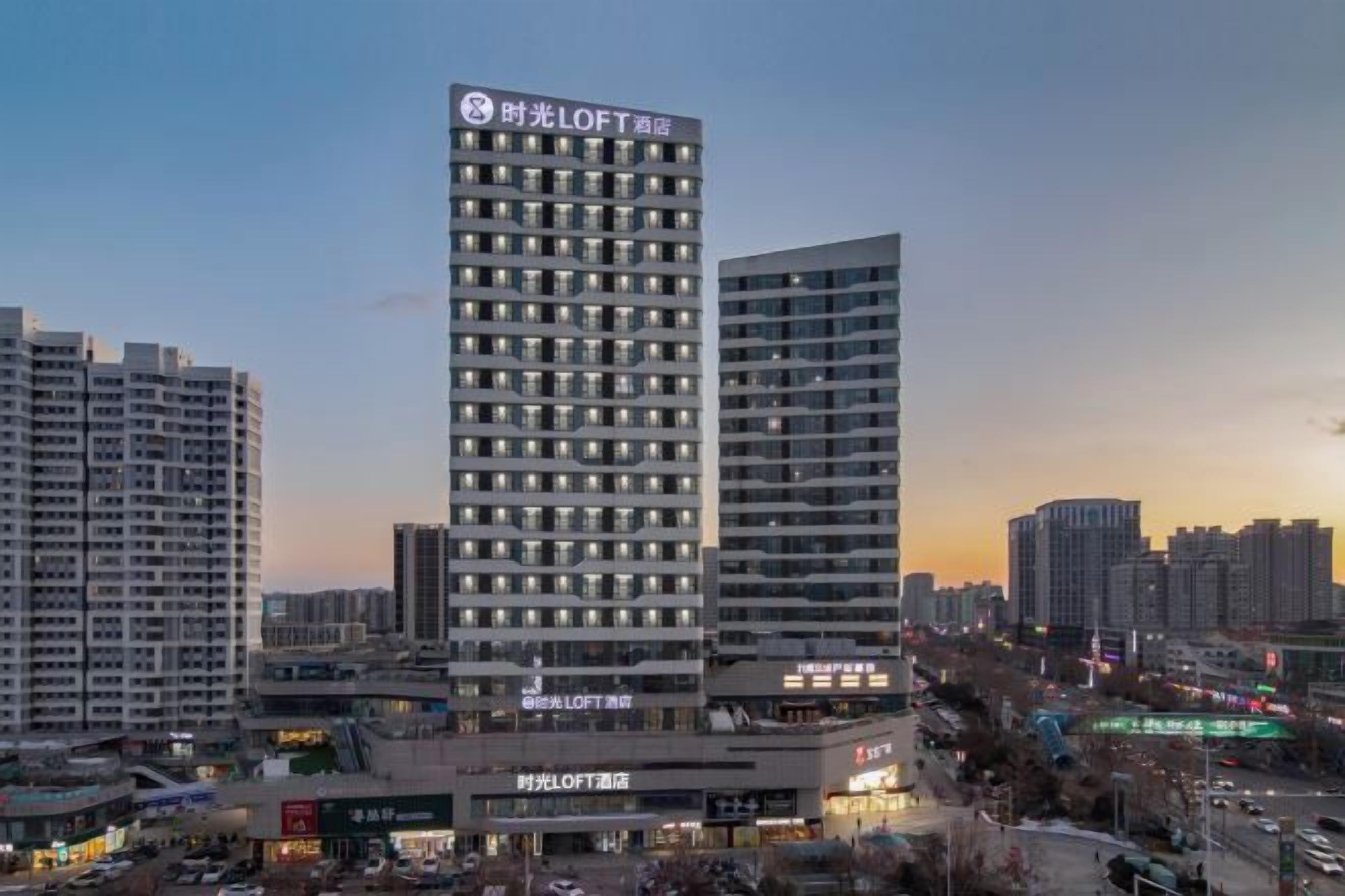 Um edifício alto com vários andares, possivelmente um hotel ou prédio de escritórios, com uma placa de destaque no topo.