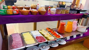 Buffet com diversos alimentos e bebidas.